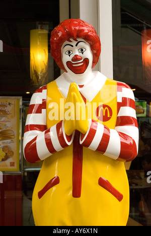 Ronald McDonald greeting customers with the traditional Thai greeting called a wai at the ...