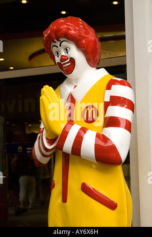 Ronald McDonald greeting customers with the traditional Thai greeting called a wai at the ...