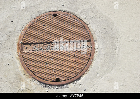Street lighting manhole cover in Los Angeles. High voltage electricity ...