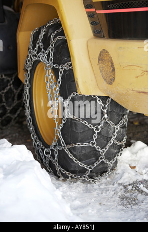 snow chains on a vehicle tire, snow chain obligation in winter snow ...