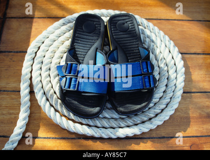 Coiled rope on teak deck. Decorative coiling is called 'cheesing' or ...