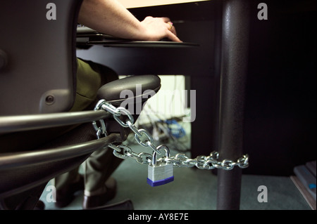 Office employee executive is chained to office desk and chair Stock ...