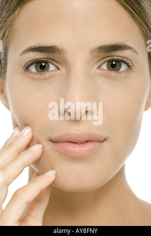 Face, fingers on cheek and a woman in studio for positive attitude ...