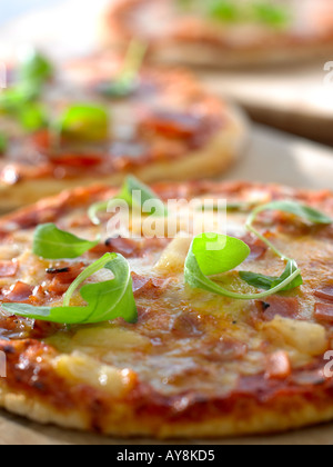 A three cheese pizza with rocket Stock Photo - Alamy