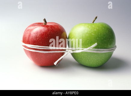 "Red apple, green apple, "tied together" with string Stock Photo - Alamy