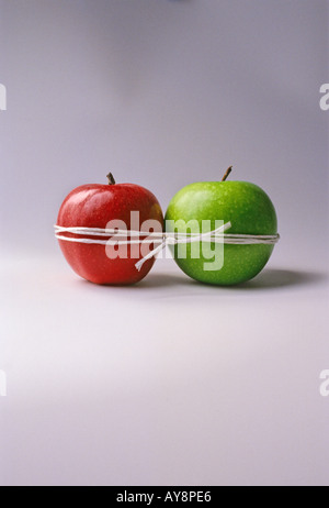 "Red apple, green apple, "tied together" with string Stock Photo - Alamy