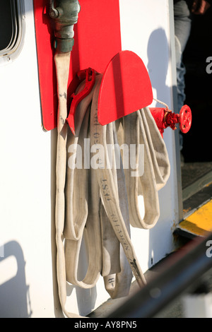 an fire hose hanging on the wall in an staircase Stock Photo - Alamy