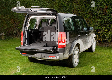 Rear view of a Land Rover Discovery climbing a steep off-road slope ...