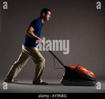 MAN WALKING WITH FLYMO VISION COMPACT 330 LAWNMOWER Stock Photo - Alamy