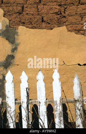 Old adobe building is crumbling into disrepair. Long abandoned, wooden ...