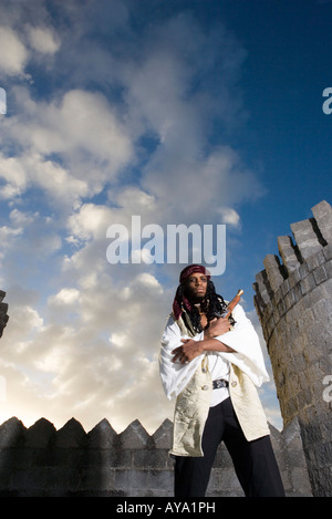 Portrait of a pirate armed with a pistol with castle turrets and ...