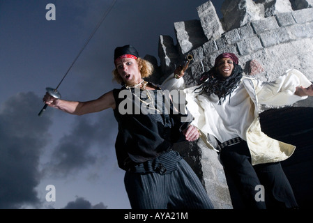 Low angle view of pirates brandishing a sword and a gun Stock Photo - Alamy