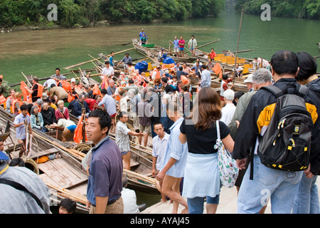 Tourists ride in a cane boat along a stream in the Spreewald in ...