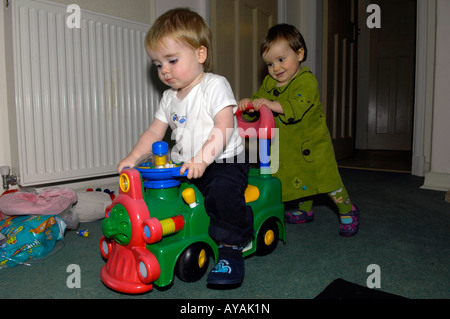 cousins boy girl toddlers one and two year old babies fun play together family Stock Photo - Alamy