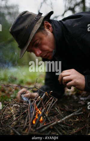 A man makes fire during a bushcraft course Stock Photo - Alamy