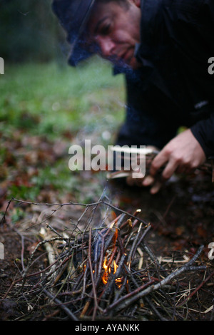 A man makes fire during a bushcraft course Stock Photo - Alamy