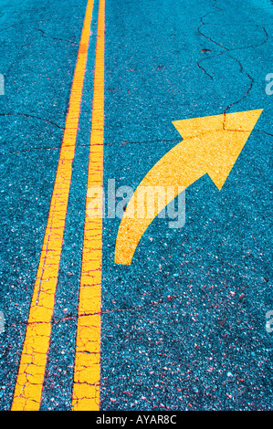 Curved Arrow road sign painted on bitumen asphalt road in white paint ...