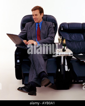 Business man using laptop in black suit with panoramic city view ...