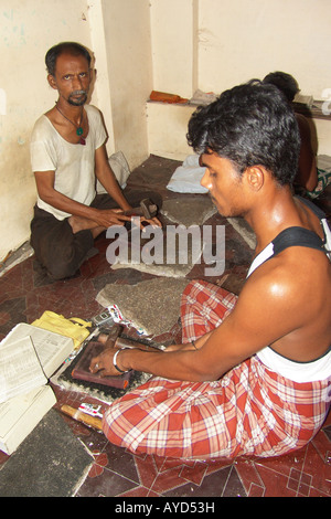 Workers making silver leaf or foil for fruits and sweets Stock Photo ...