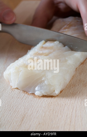 Raw cod loin fillet fish on marble board. Black background. Top view ...