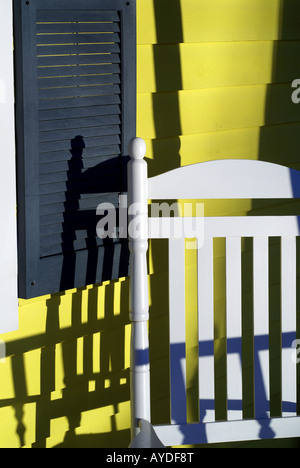 Yellow wooden chair, back painted in rainbow colours, standing in a ...