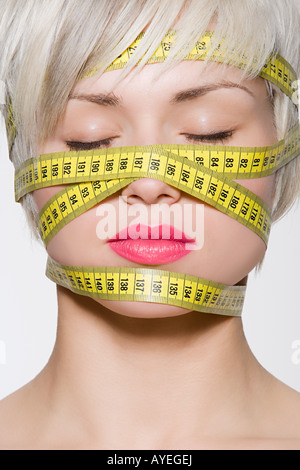 Caucasian woman with measuring tape around her neck Stock Photo - Alamy