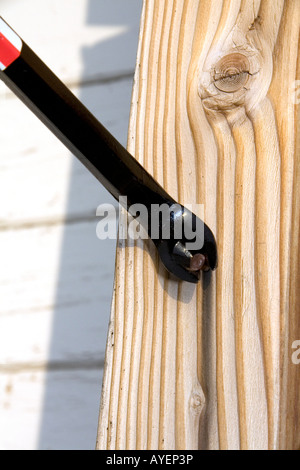 A cats paw crowbar pulling a nail out of a piece of wood Stock Photo ...