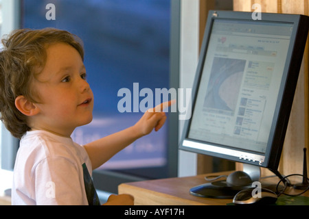 Child using technology. 5 year old boy with a smart phone or iPhone ...