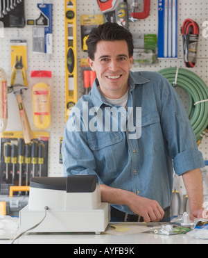 Portrait of store clerk standing at counter in supermarket Stock Photo ...