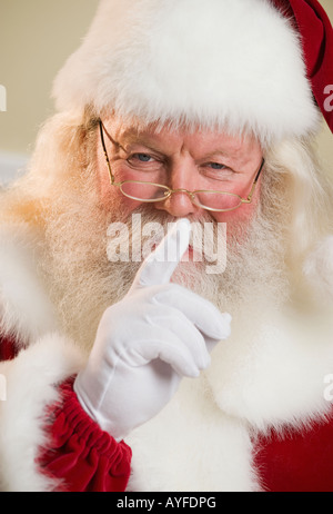 Santa Claus shushing Stock Photo - Alamy