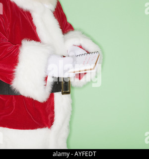 Santa claus writing list on scroll Stock Photo - Alamy