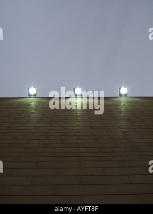 three security lights on office block Stock Photo - Alamy