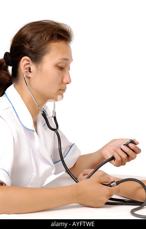 Asian female doctor measuring blood pressure with sphygmomanometer at ...