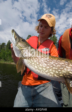 Fisherman holding big Northern pike freshwater fish caught in Ross lake ...
