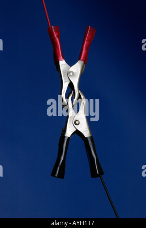 two large crocodile clips with dark blue background Stock Photo - Alamy