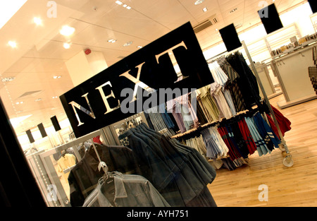 Next plc retail business store close up part of Christmas tree & Merry ...