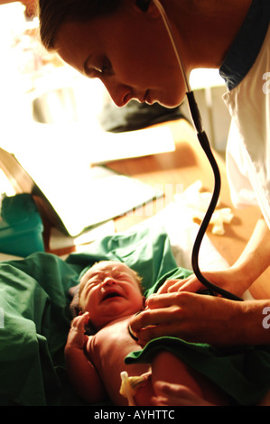 Doctors checking newborn baby boy after birth. Edina Minnesota USA ...