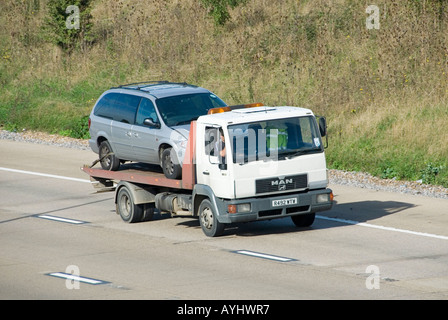 Car transporter pickup truck loaded with one car with additional car ...