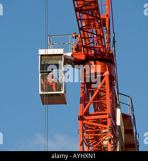 Crane driver in cab of tower crane on construction site Stock Photo - Alamy