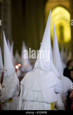 Row of hooded penitents entering Seville's Cathedral, Spain Stock Photo ...