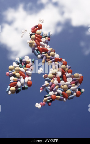 Still life conceptual mirror shot pills & tablets as a map held in hand ...