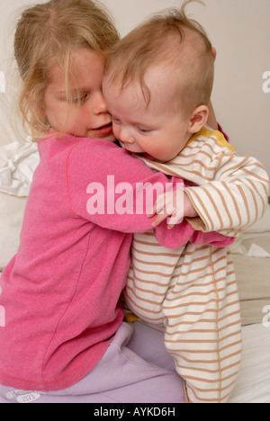 Loving brother hugging his baby sister during a birthday photoshoot ...