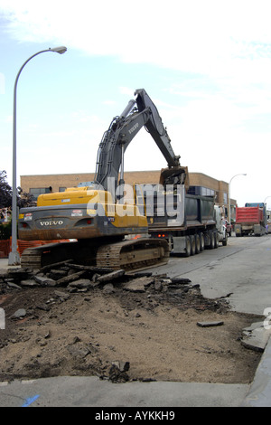 An excavator ripping up the road surface Stock Photo - Alamy