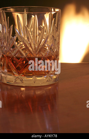 Festive Christmas by a roaring log fire and decorated Christmas tree ...