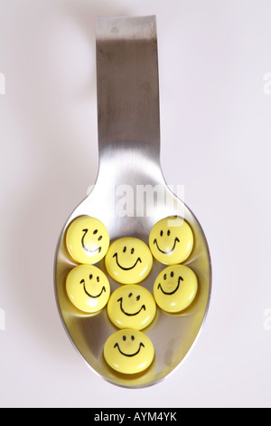 Smiley faces in silver spoon Stock Photo - Alamy
