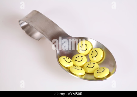 Smiley faces in silver spoon Stock Photo - Alamy