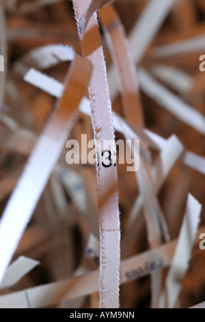 Shredded white paper on light yellow background Stock Photo - Alamy
