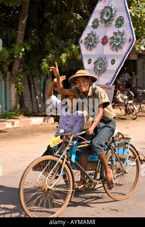 Stock photograph of a trishaw carrying offerings in a street parade at ...