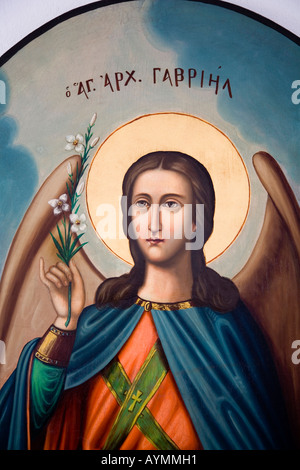 The Annunciation. Archangel Gabriel is offering a white lilly flower to ...