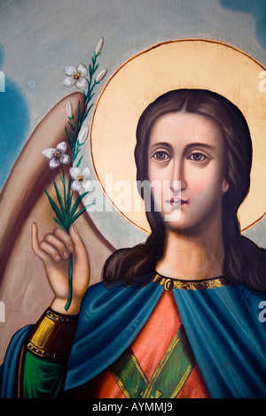 The Annunciation. Archangel Gabriel is offering a white lilly flower to ...